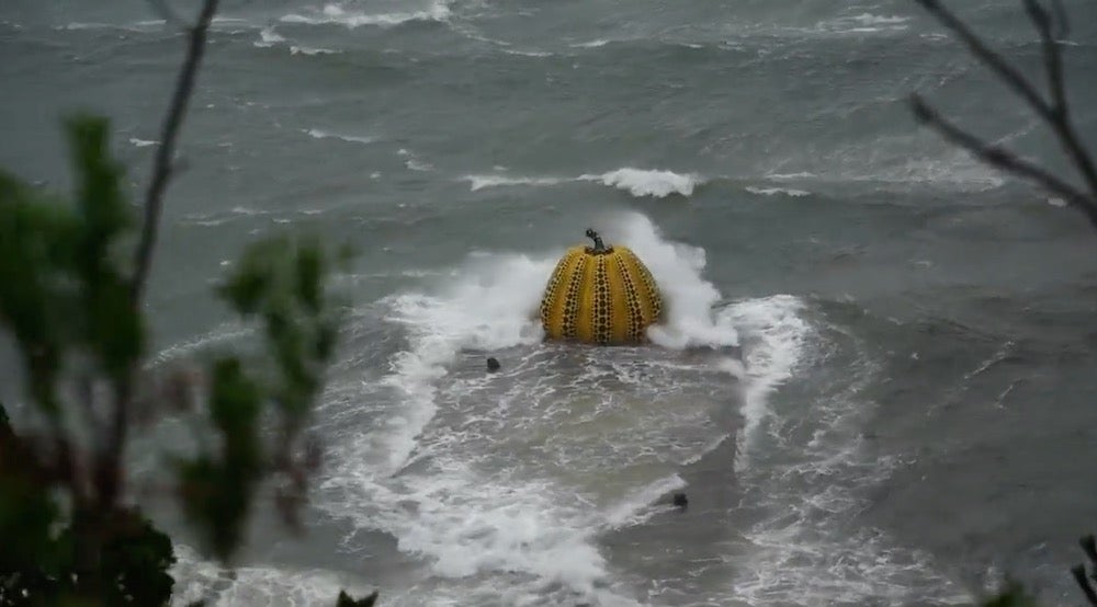strong waves slam into Yayoi Kusama’s “Yellow Pumpkin” moments before it is washed away ...