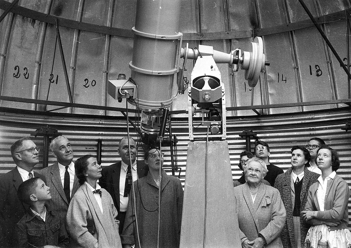 People gazing at telescope in observatory, The University of Iowa ...