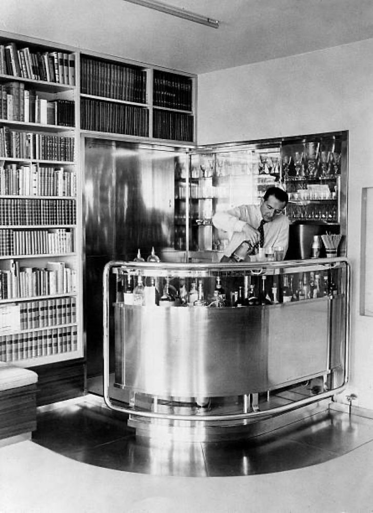 Fritz Lang makes himself a drink at the bar of his flat in Berlin, 1932 ...