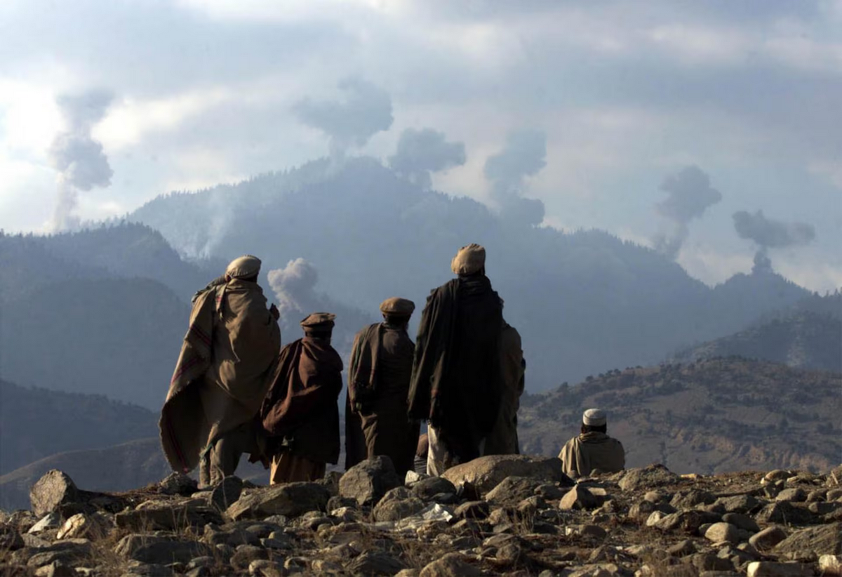 Erik de Castro, Anti-Taliban Afghan fighters watch several explosions from U.S. bombings in the ...